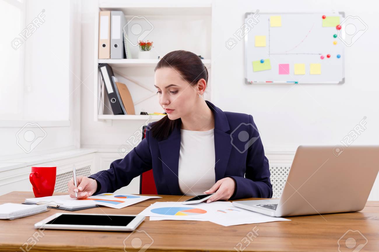 Business woman reading document at office desktop – GDN Classified ...